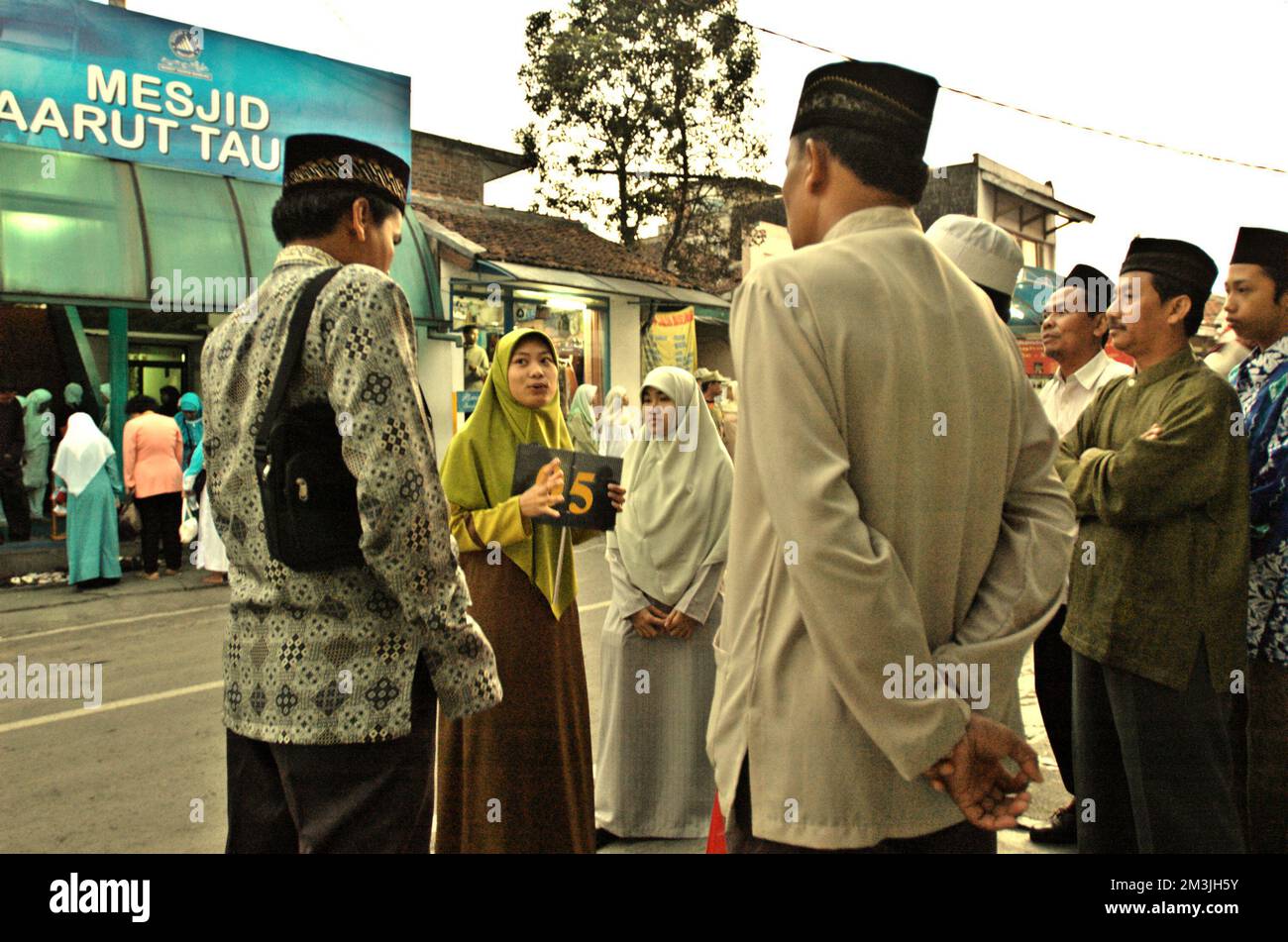 A woman guide is explaining the day's program to a group of religious ...