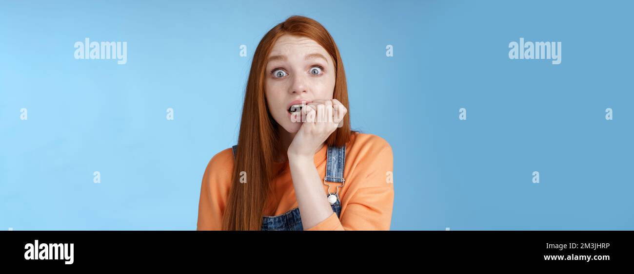 Scared unconfident anxious young trembling redhead girl wide eyes ...