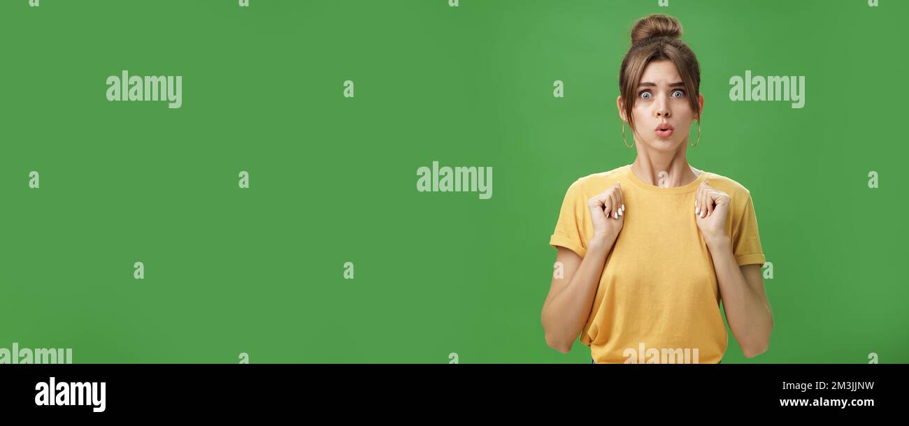 Studio shot of silly insecure and timid young wife feeling troubled and ...