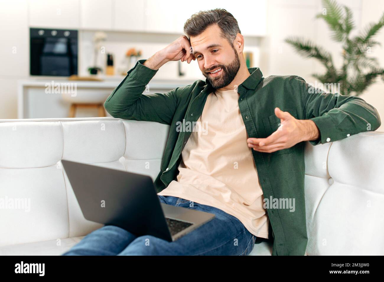 Handsome happy man home uses hi-res stock photography and images - Alamy