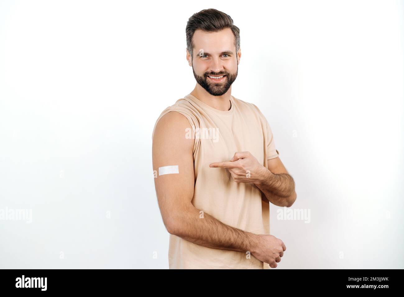 Got a vaccine. Happy caucasian man, with a plaster on his shoulder ...