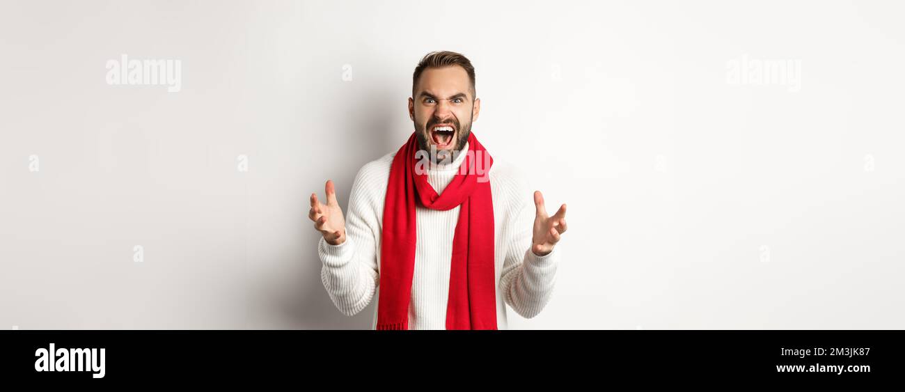 Christmas holidays and New Year concept. Angry man looking with hatred ...