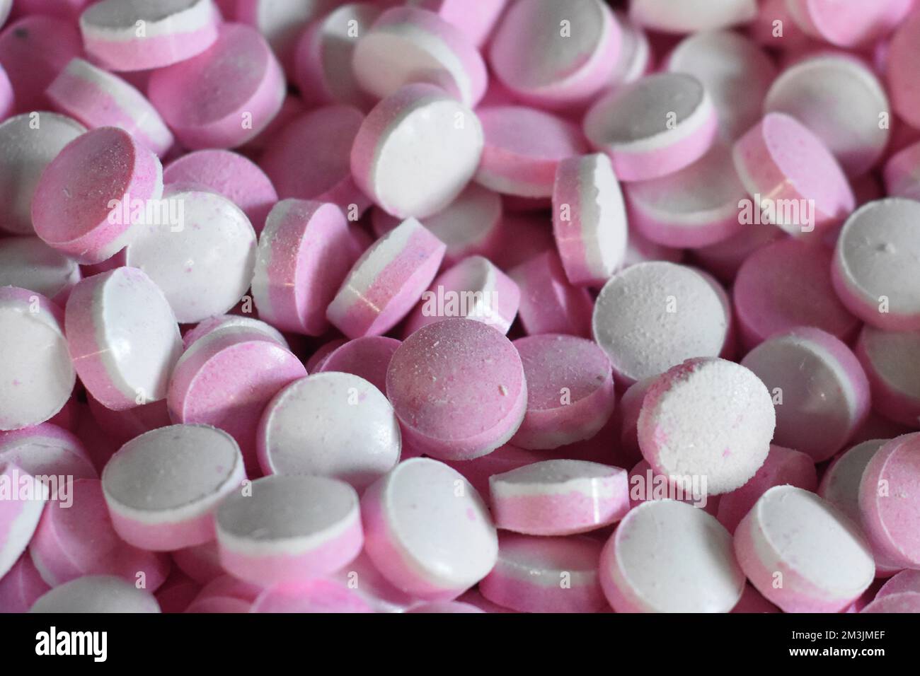 Traditional mints of pink, blue and yellow colors with circular and ...