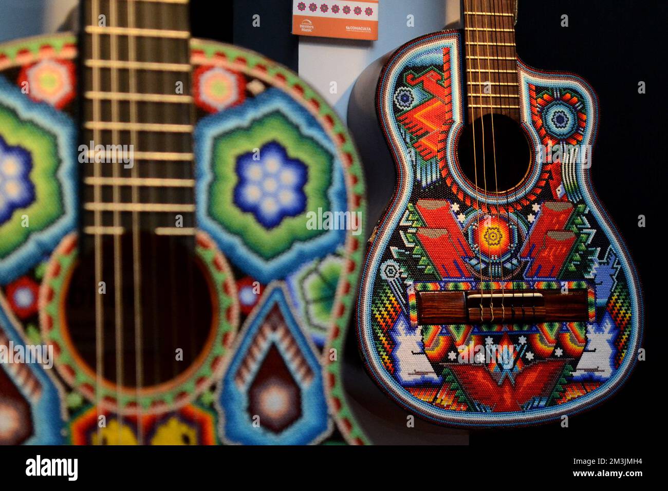 a guitar decorated with designs and ornaments made of multicolored ...