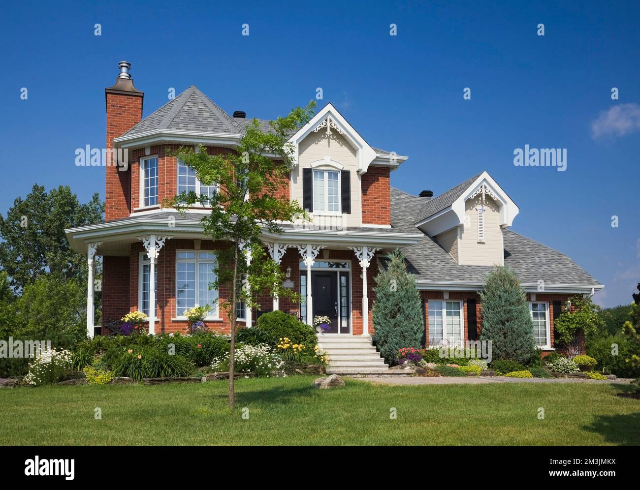 Red brick Victorian and contemporary cottage style home with landscaped ...