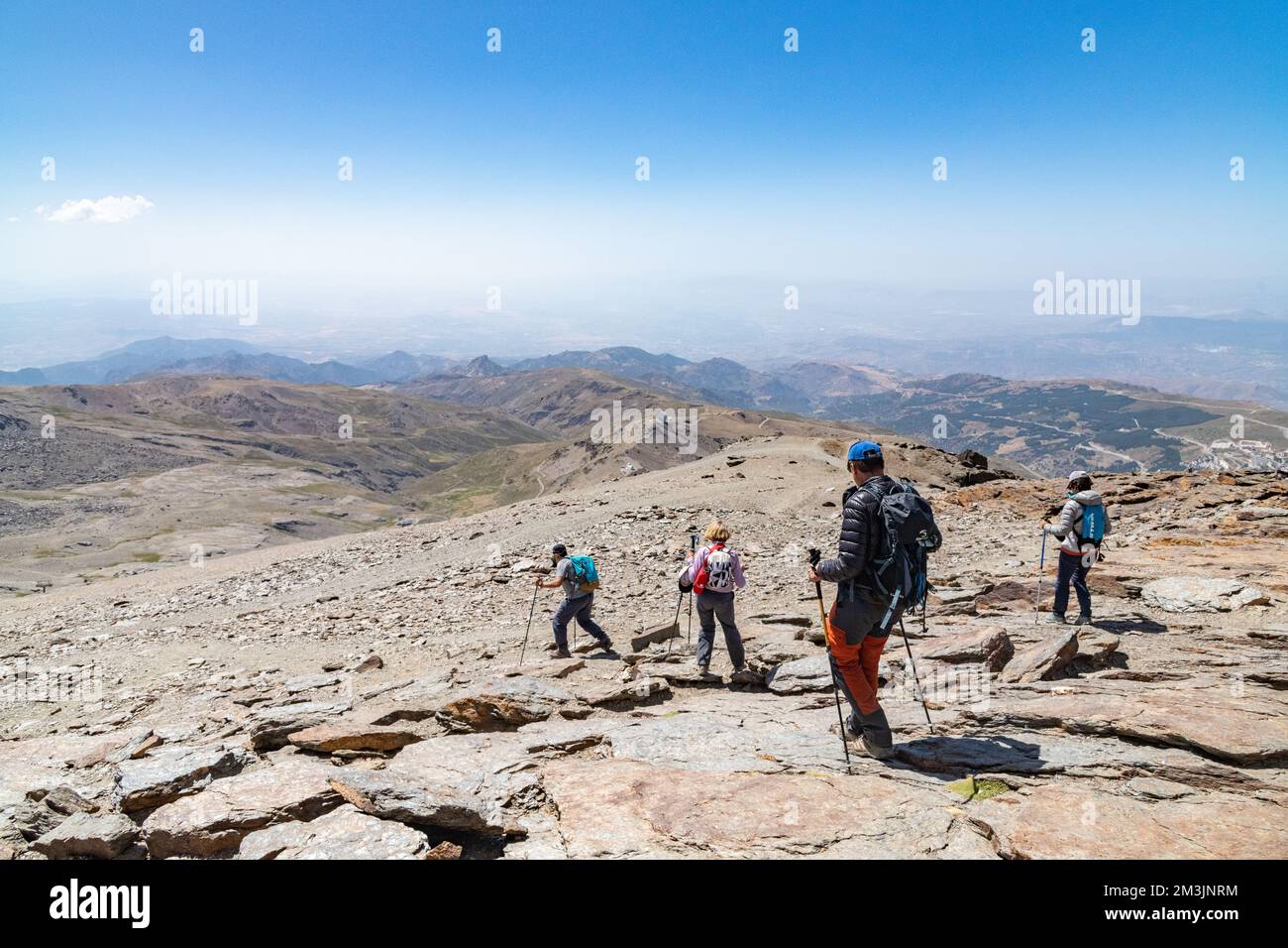A group of hikers exploring the Sierra Nevada mountain range at Pico ...