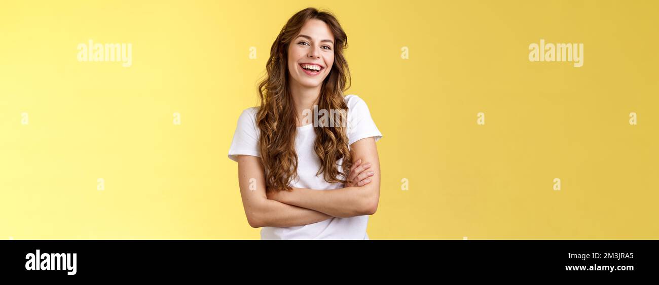 Entertain me. Friendly charismatic female long curly haircut laughing ...