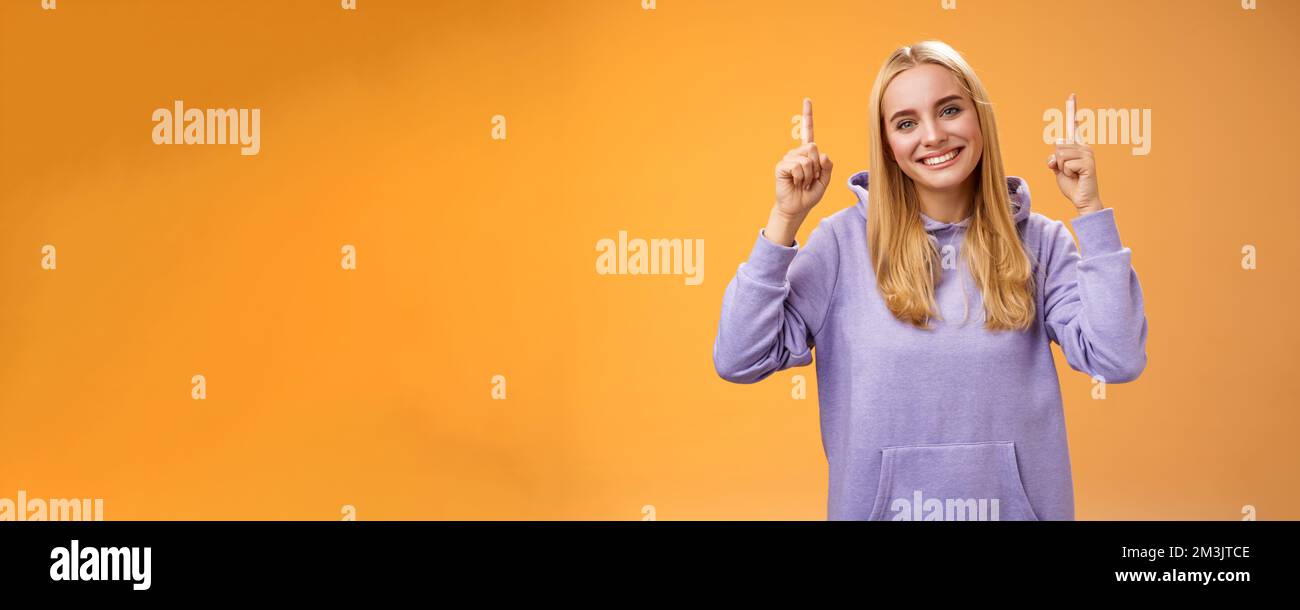 Helpful friendly-looking supportive charming female friend pointing up ...
