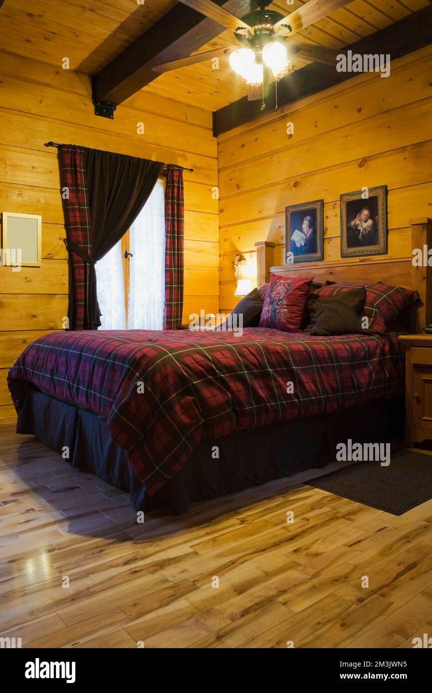 Double bed with red and brown checkered bedspread and matching window ...