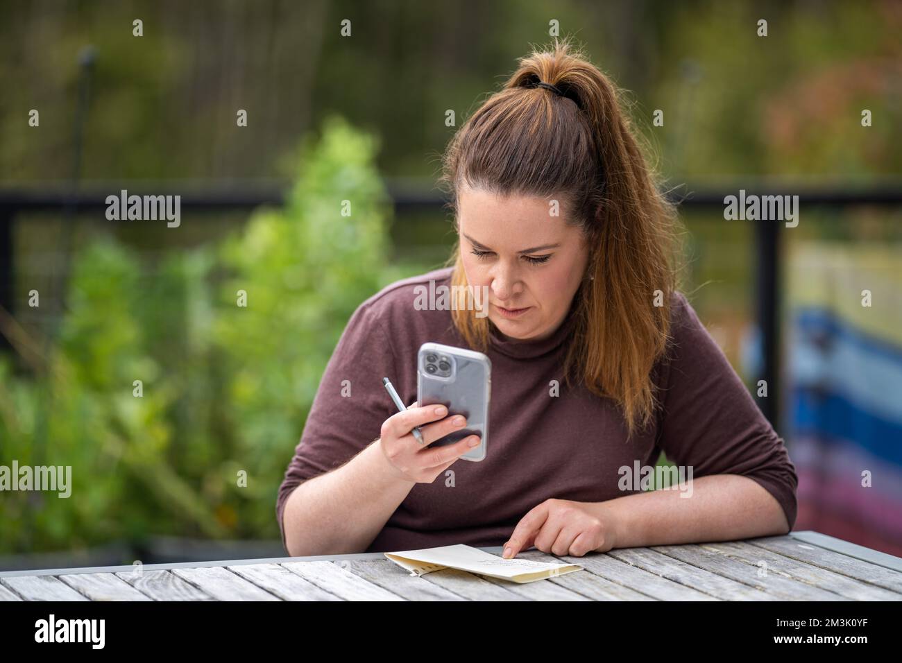 mature university student writing outside studying in australia Stock ...