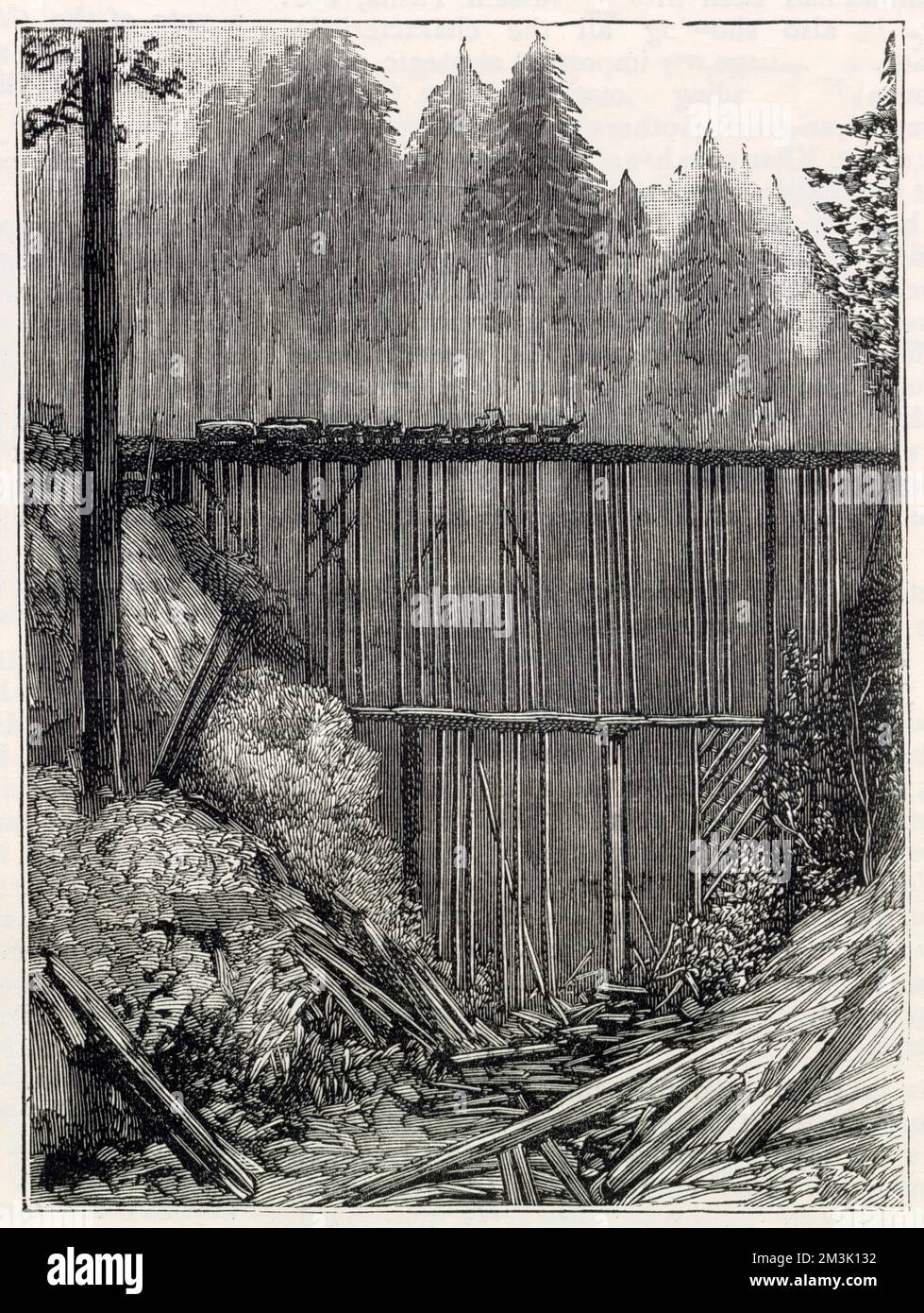 A deep gorge, with a spindly two tier bridge built across it, in the ...