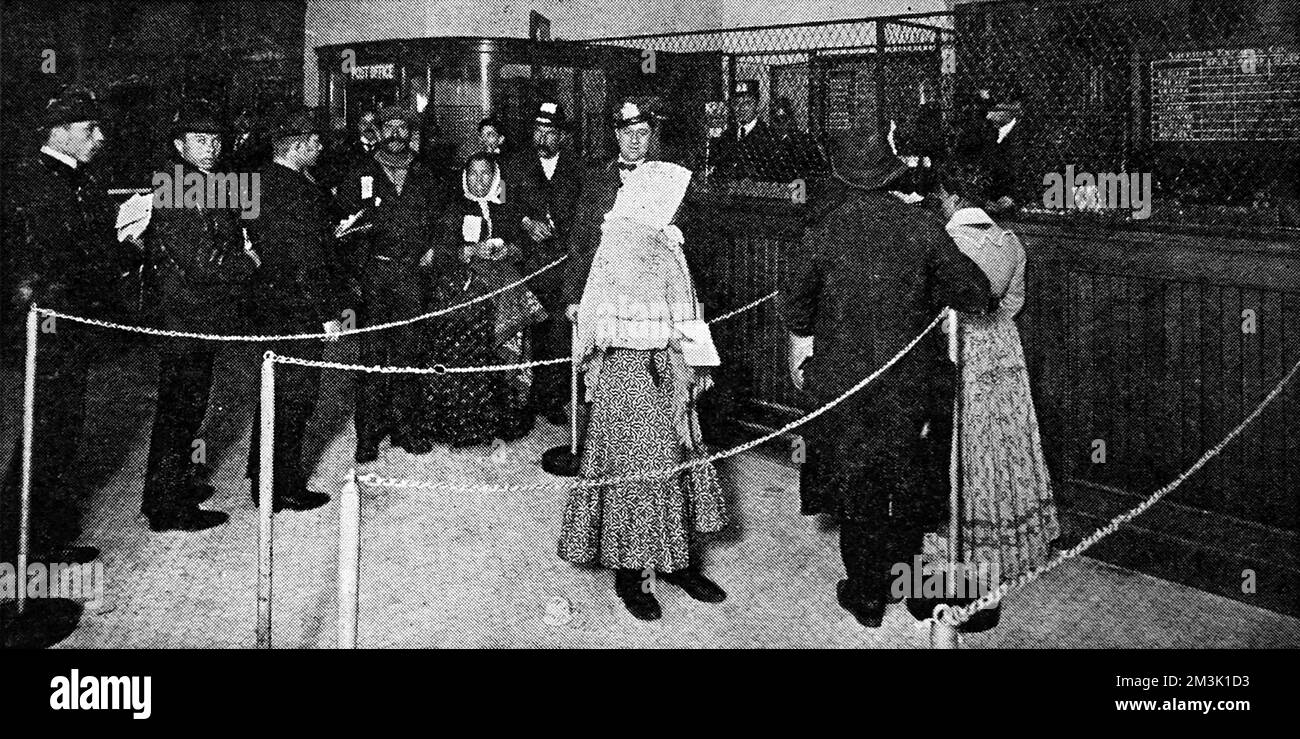 Photograph of immigrants queueing up at a counter to exchange their ...