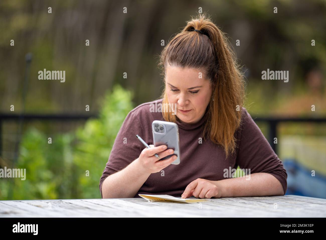mature university student writing outside studying in australia Stock ...