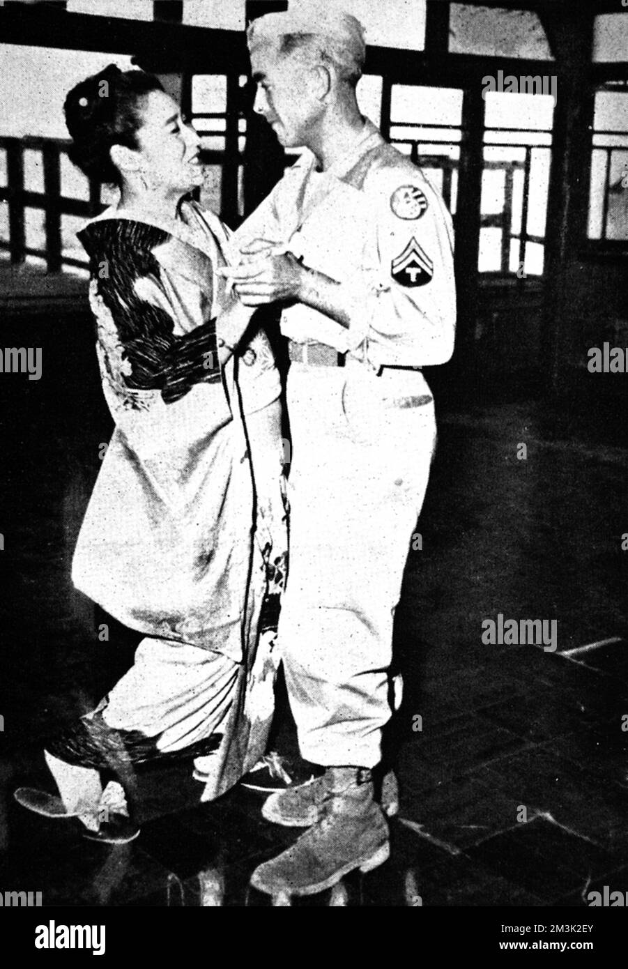 American serviceman dancing with a Japanese Geisha in a Tokyo Geisha ...