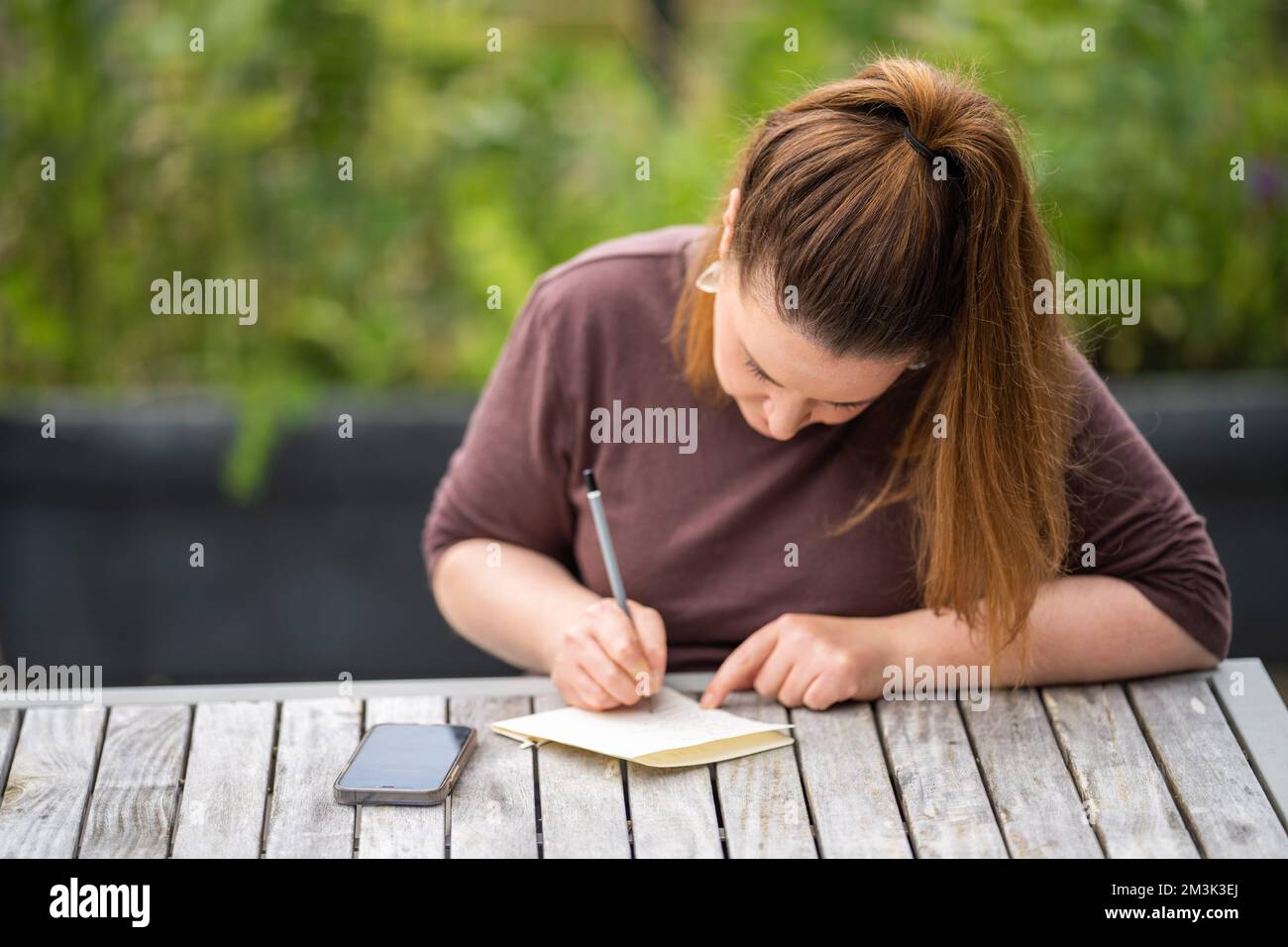 women teacher writing outside. wprking writing notes in a school Stock ...