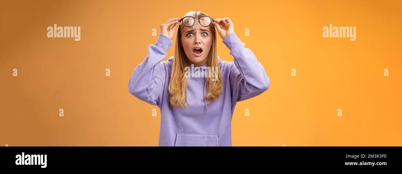 Shocked concerned young woman looking student ruin work staring ...