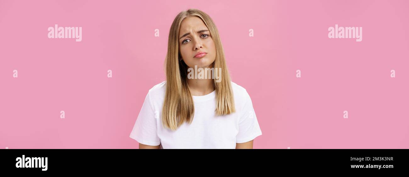 Sad girl whining tilting head raising eyebrows in upset expression and ...