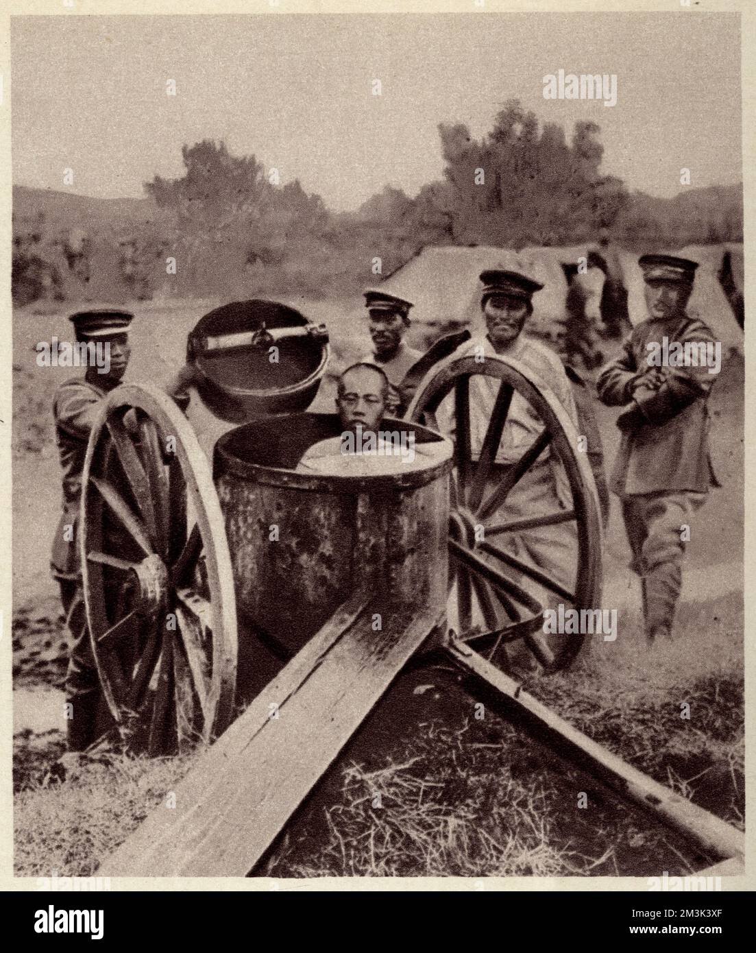 A Japanese soldier taking a bath in a wheeled water tank, at the siege ...