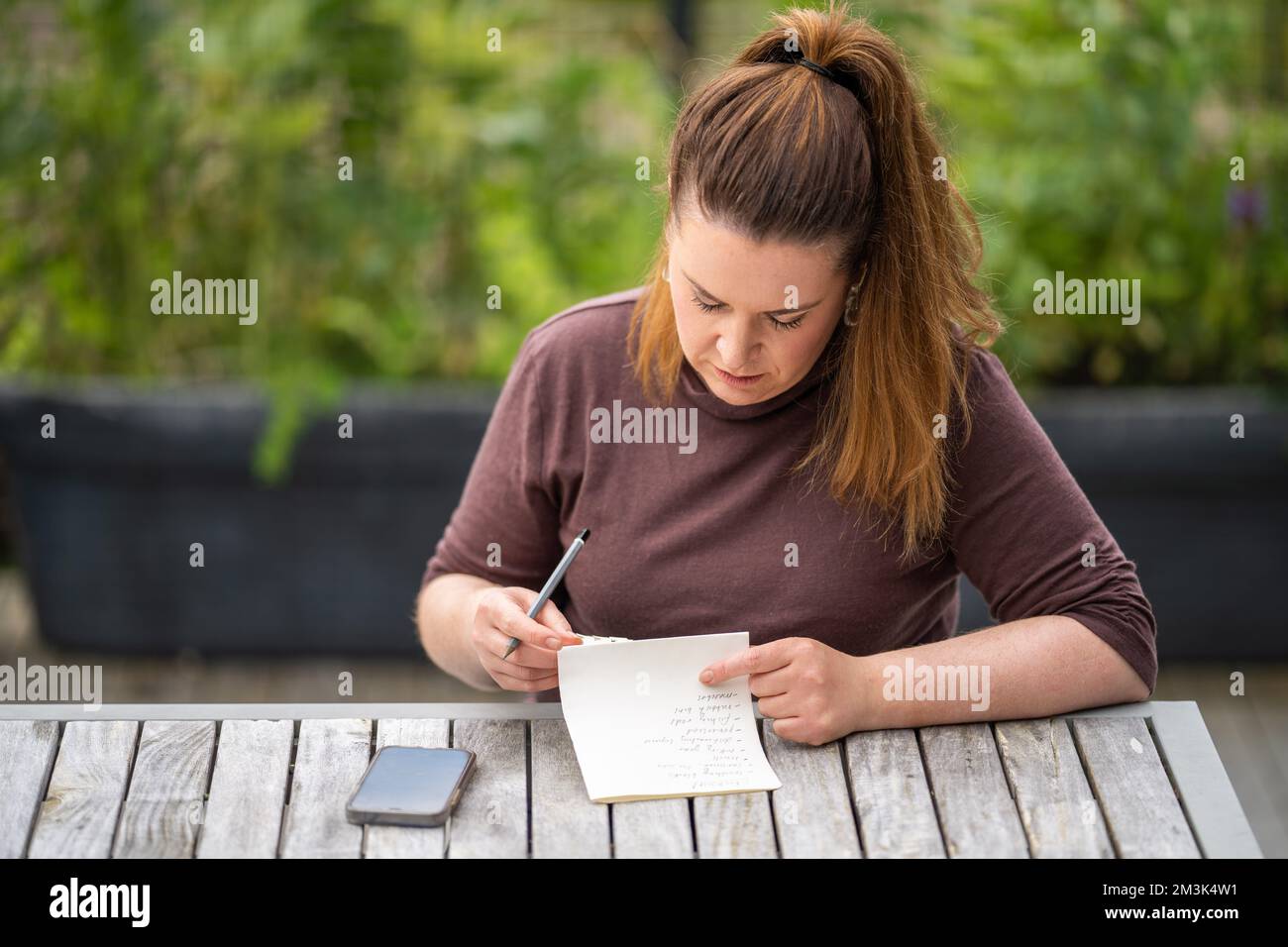 women teacher writing outside. wprking writing notes in a school Stock ...