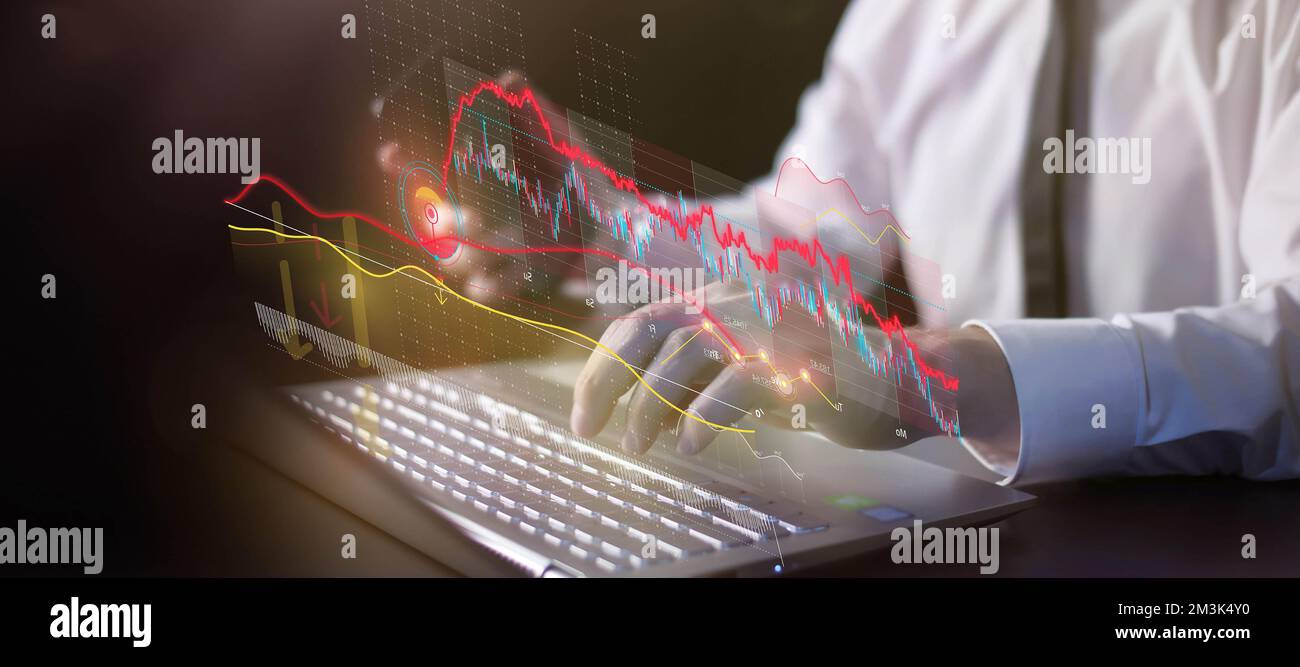 Working on laptop and graphs of stock market crash Stock Photo - Alamy