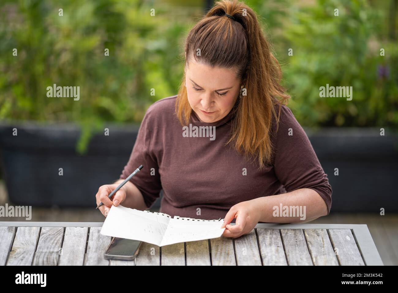 women teacher writing outside. wprking writing notes in a school Stock ...