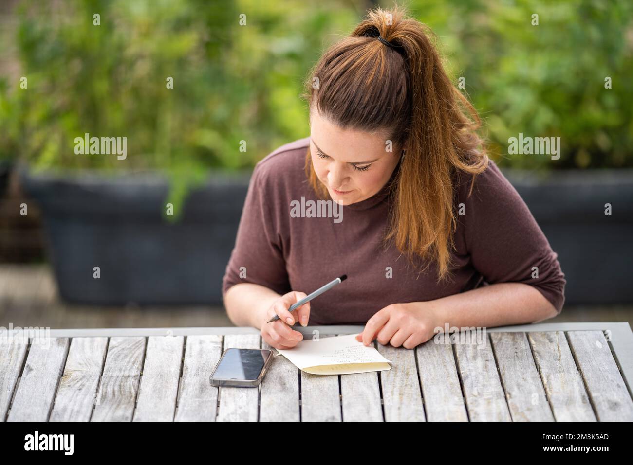 women teacher writing outside. wprking writing notes in a school Stock ...