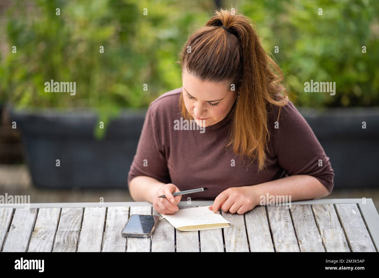women teacher writing outside. wprking writing notes in a school Stock ...