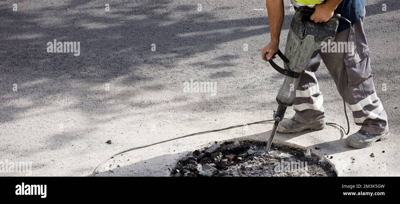 hydraulic hammer in the hands of an operator in uniform works the ...