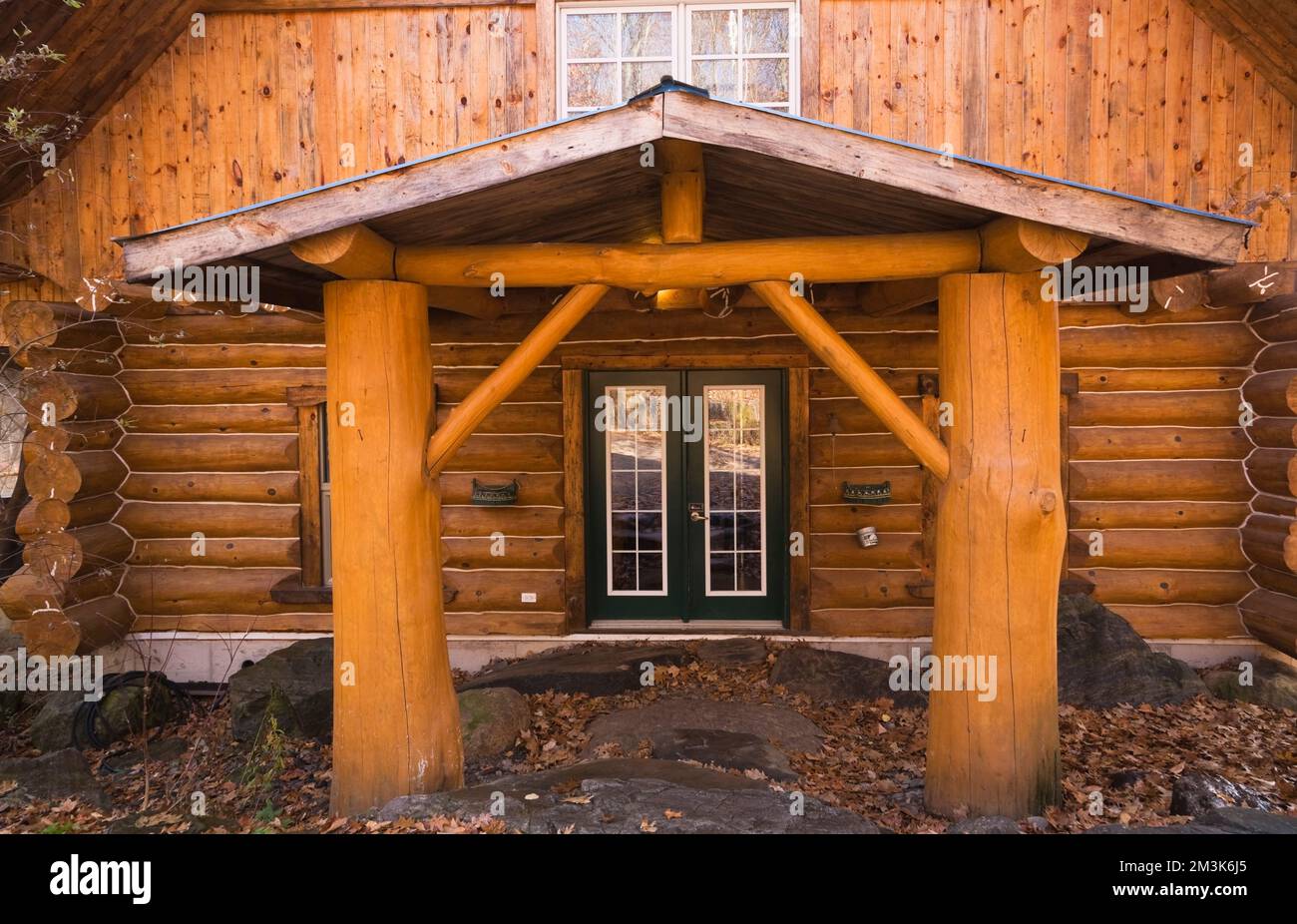 A-frame log cabin facade with portico in autumn Stock Photo - Alamy