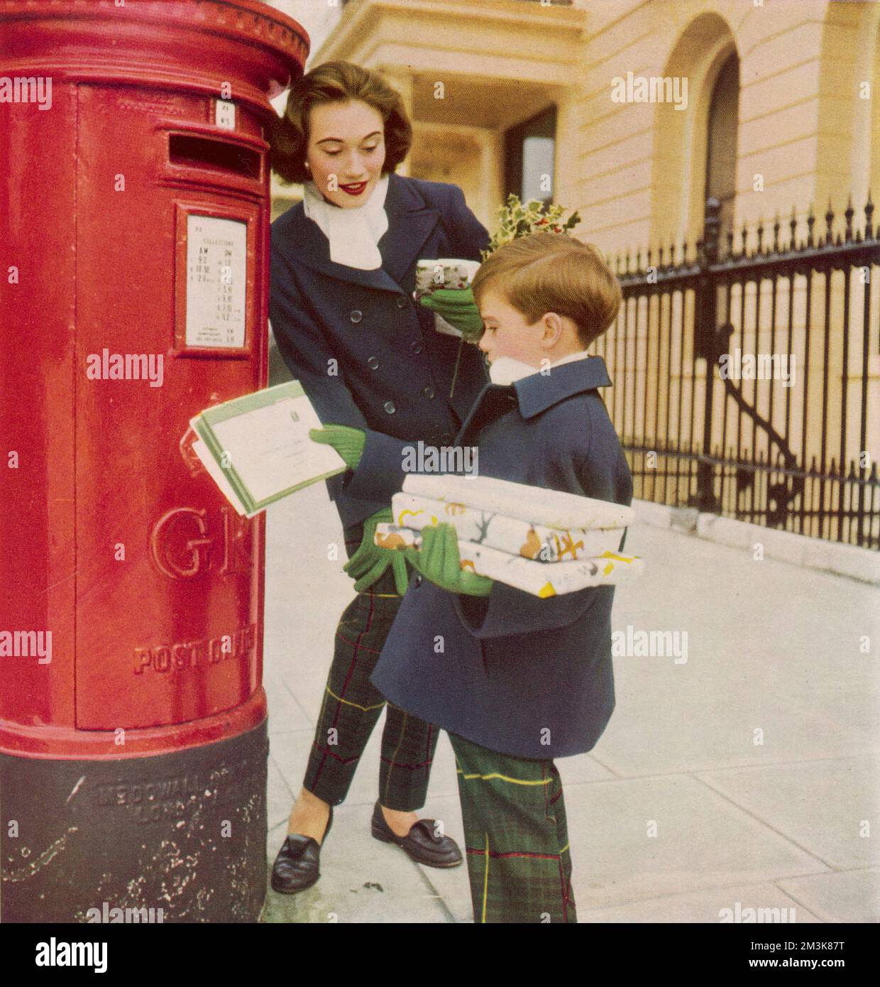 photograph-showing-a-young-boy-with-his-mother-posting-christmas-cards