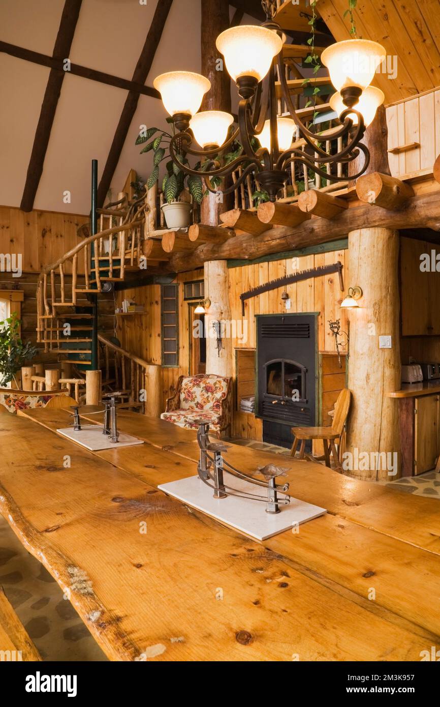 Antique chandelier above split log dining table in dining room inside ...