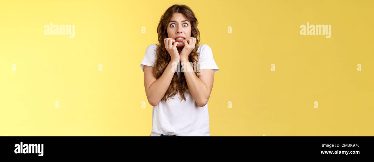 Scared timid insecure unconfident european girl curly haircut hold ...