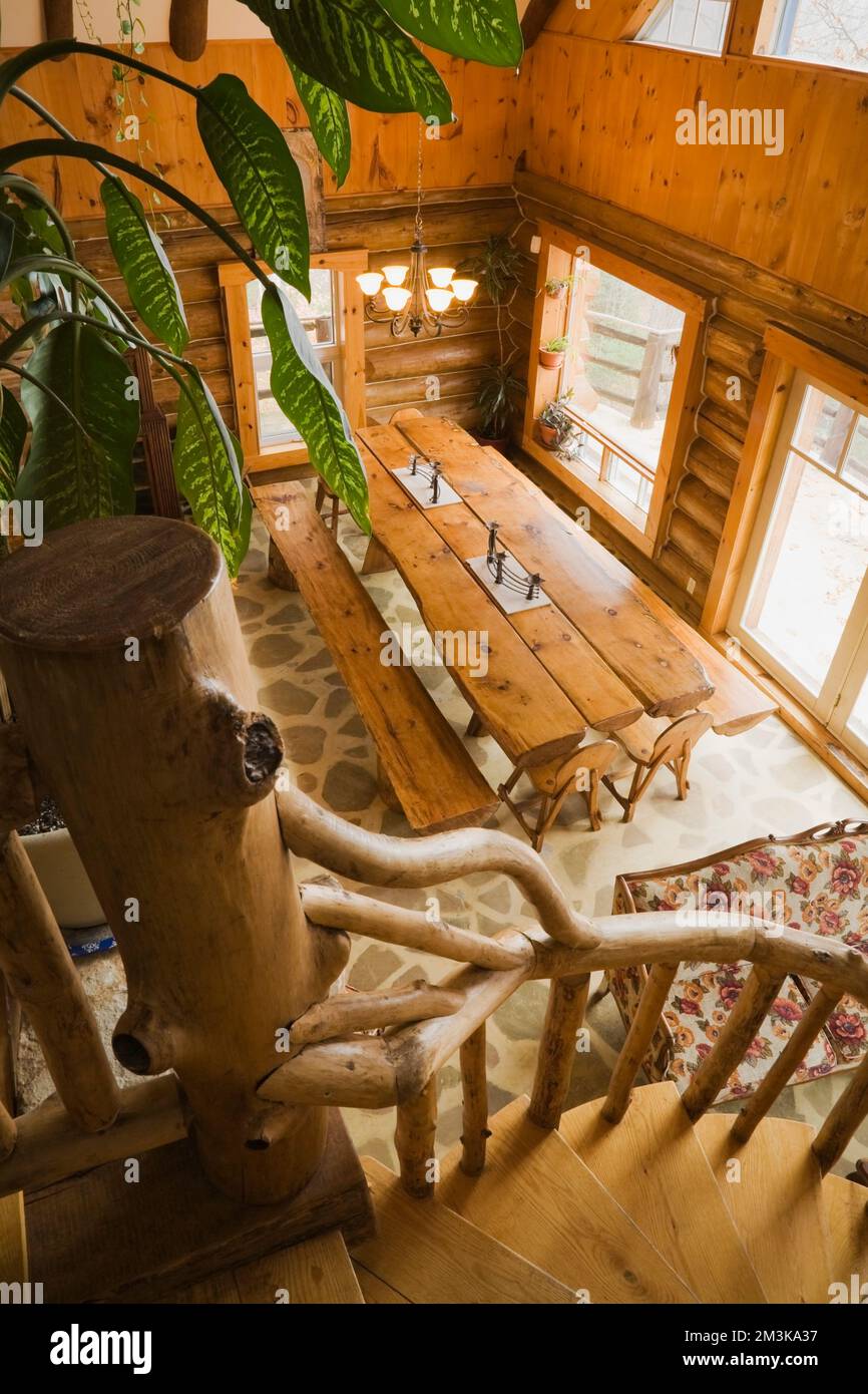 High angle view of split log dining table and benches in dining room ...