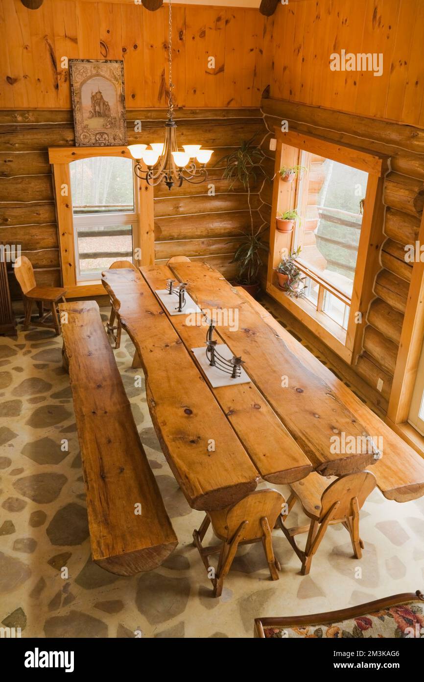 High angle view of split log dining table and benches in dining room ...