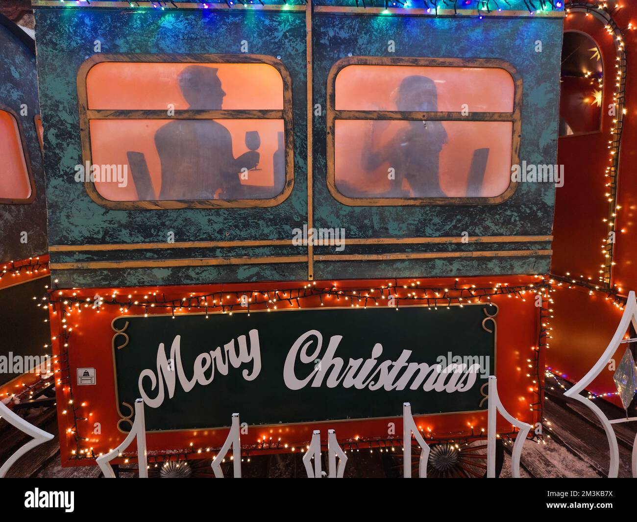 red Santa Claus Christmas train. Silhouettes of celebrating men and ...