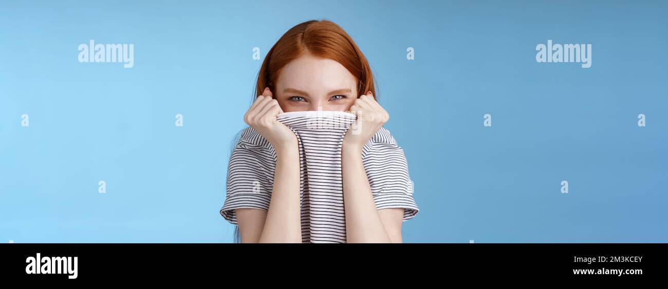 Silly flirty amused attractive playful redhead girlfriend hiding face ...