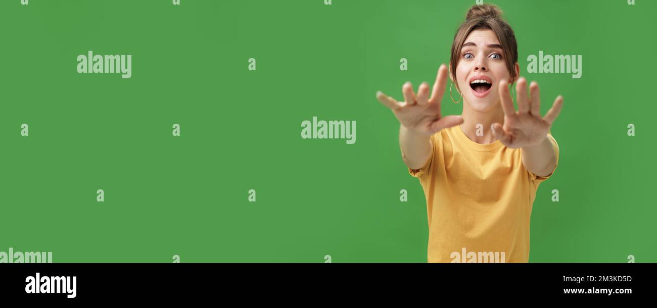 Excited and addicted goog-looking young woman reaching hands forward to ...