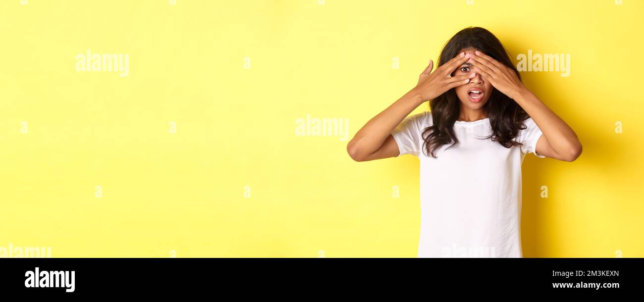 Portrait of embarrassed and shocked african-american girl, shut her ...