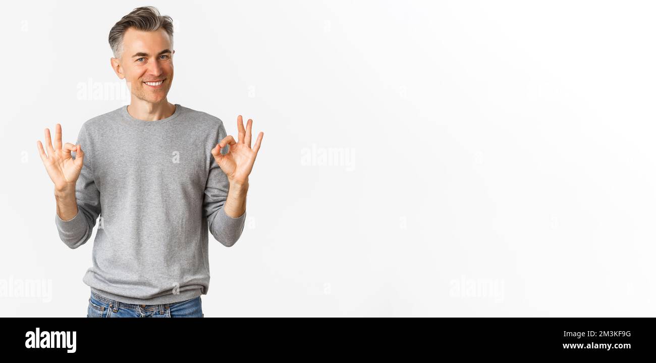 Portrait of handsome middle-aged man, smiling and looking confident ...