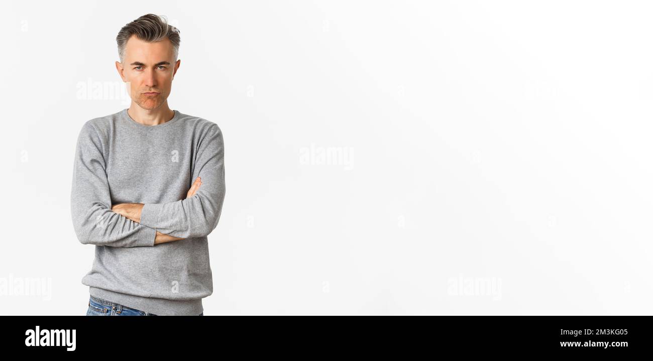 Image of angry middle-aged man feeling offended, cross arms on chest ...