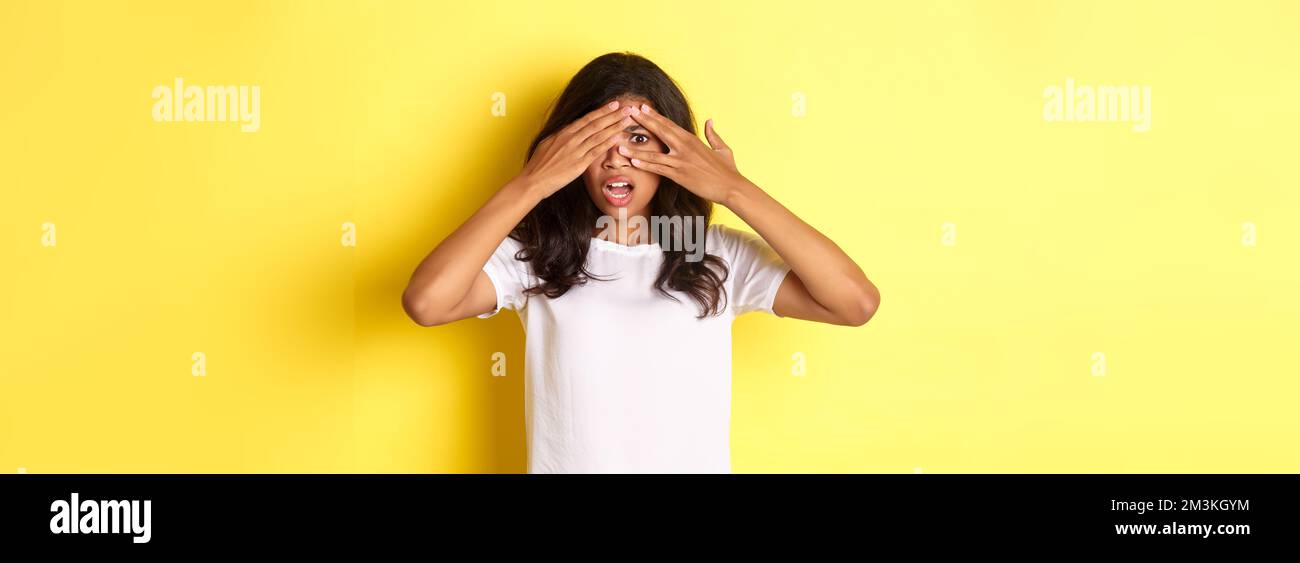 Portrait of embarrassed and shocked african-american girl, shut her ...