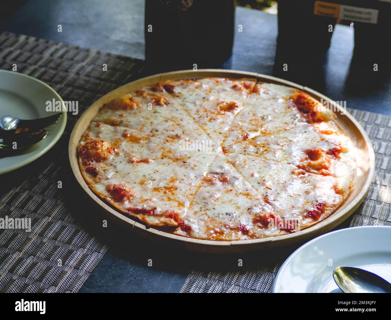 Large pizza and 2 food plates Stock Photo - Alamy
