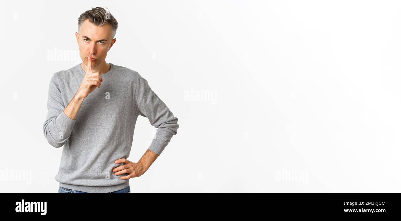 Disappointed middle-aged man with grey hair, hushing at you, scolding ...