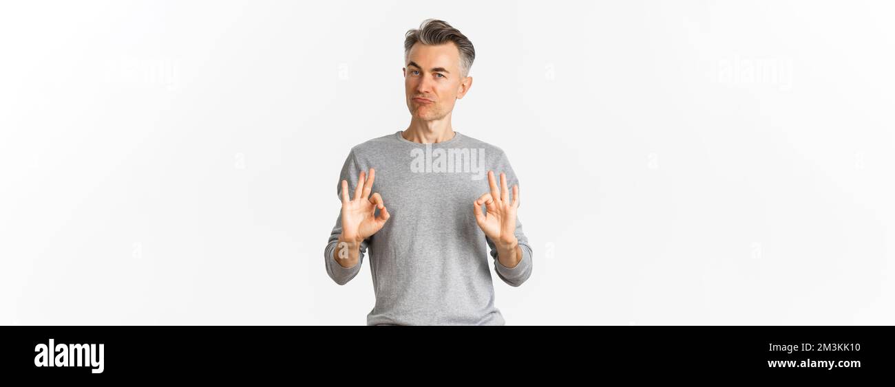 Image of impressed and satisfied middle-aged man, showing okay signs ...