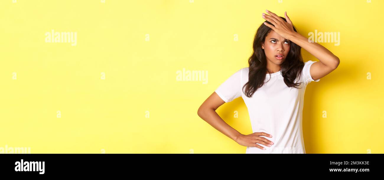 Portrait of annoyed african-american girl, slap forehead and roll her ...