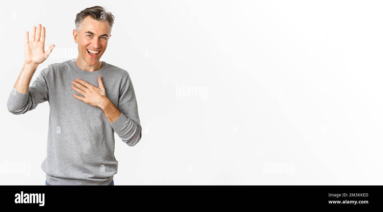 Portrait of handsome middle-aged man making promise, raising one hand ...