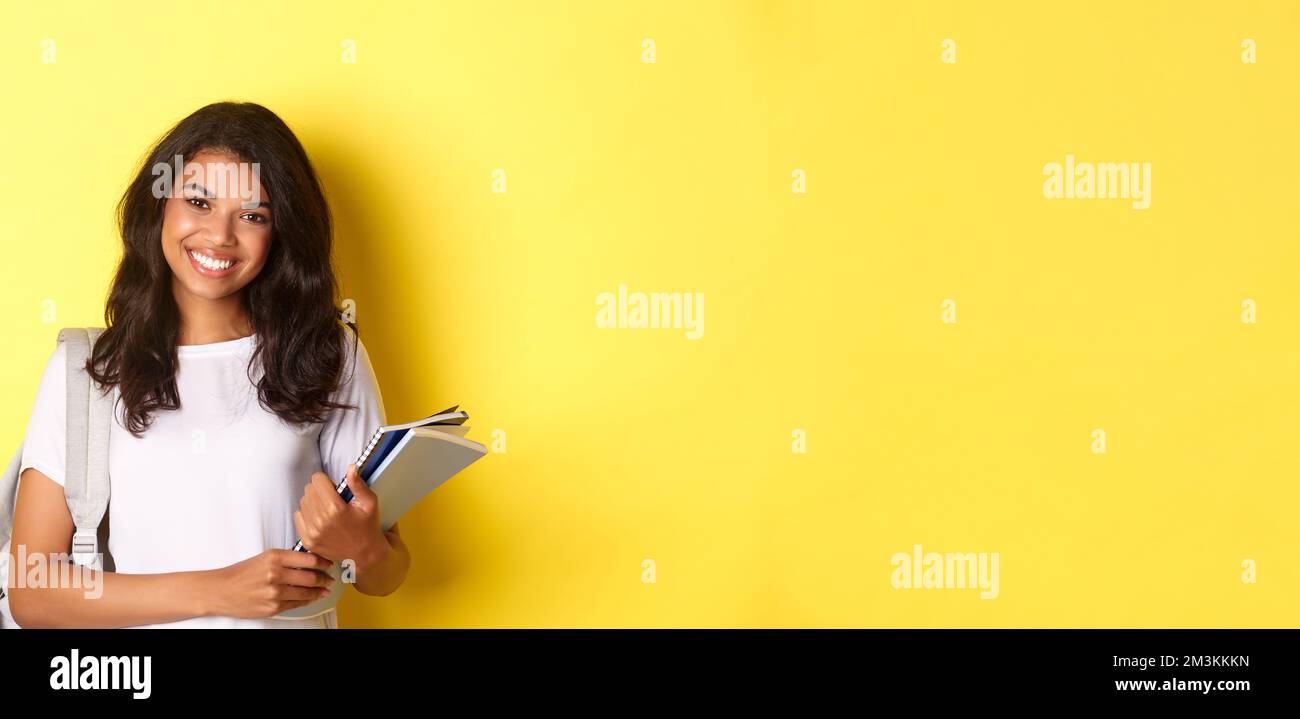 Portrait of happy african-american female college student, holding ...