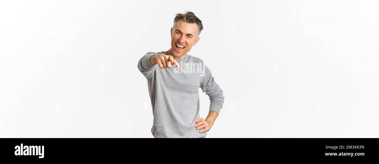 Image of handsome middle-aged man smiling and pointing finger at camera ...