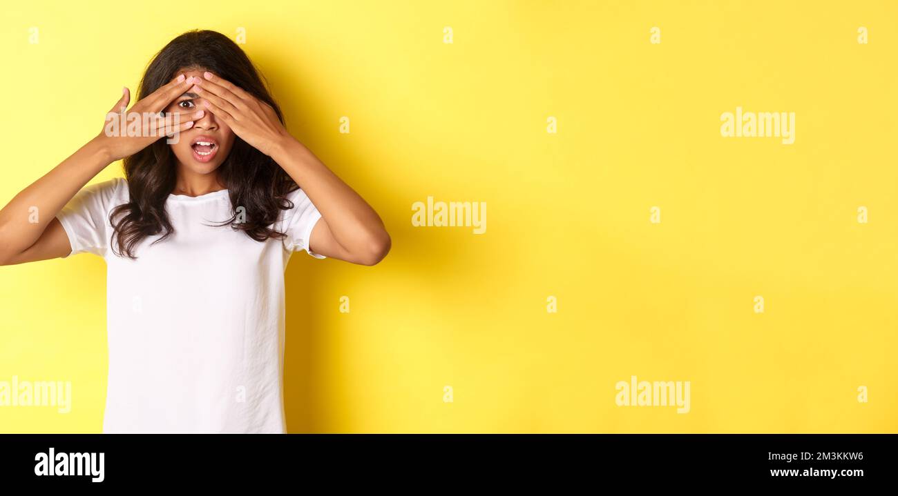 Portrait of embarrassed and shocked african-american girl, shut her ...