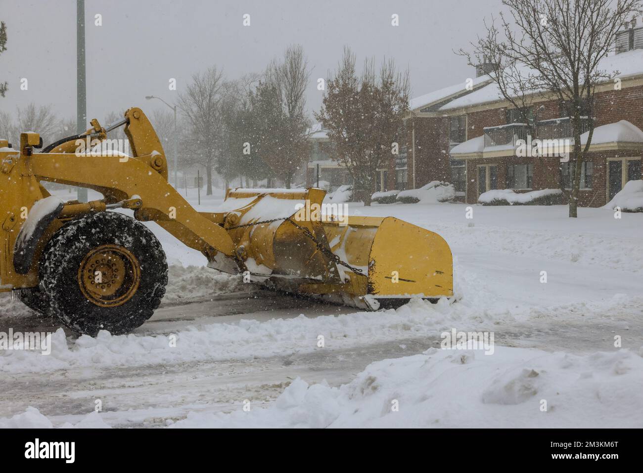 In after huge snowstorm tractor is being used to clean up snow during ...